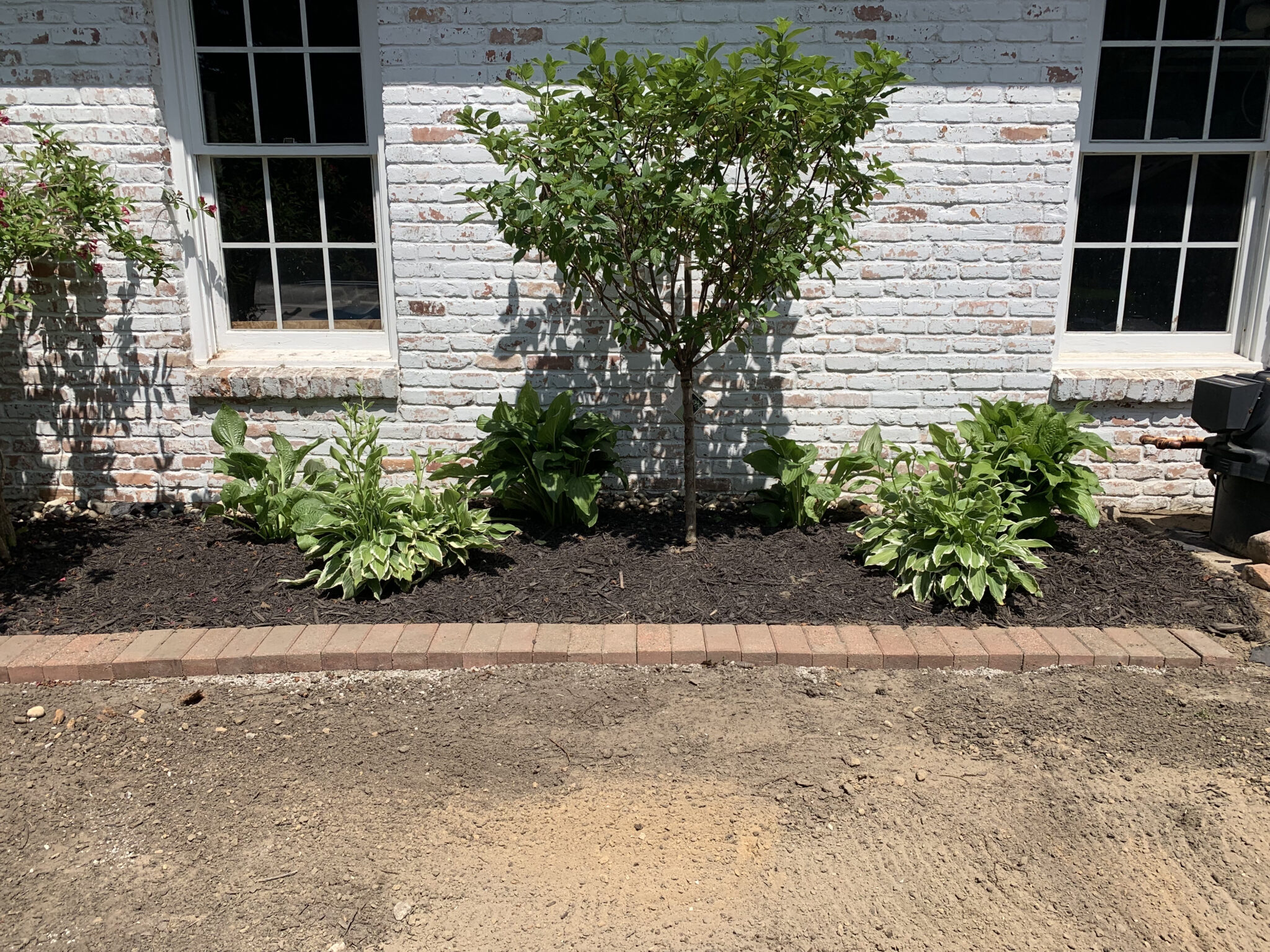 How to Install Brick Edging Around a Patio - Building Bluebird